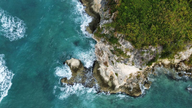 Aerial View of a Stunning Beach with Rocky Cliffs with Waves Crashing ...