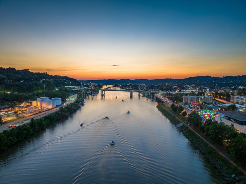 Aerial View of the Sun Setting Behind Boaters on the River Stock Photo ...