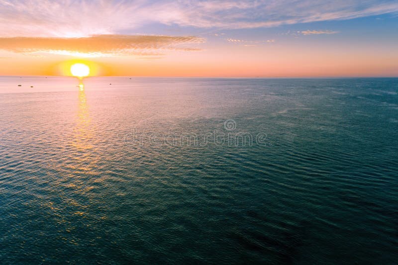 Sun Setting Over Calm Ocean Water. Stock Photo - Image of calm, scenic ...