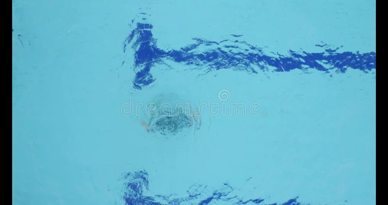 Aerial View of a Swimmer in a Swimsuit and Goggles Training in the Pool ...