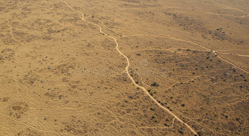 Aerial View of Tan Desert Landscape with Winding Paths Stock ...