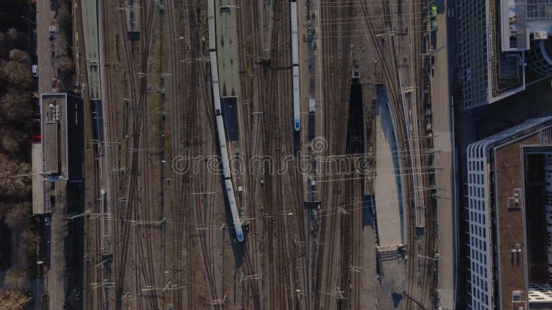 Aerial View Tracking Passenger Train Navigating a Central Station in ...