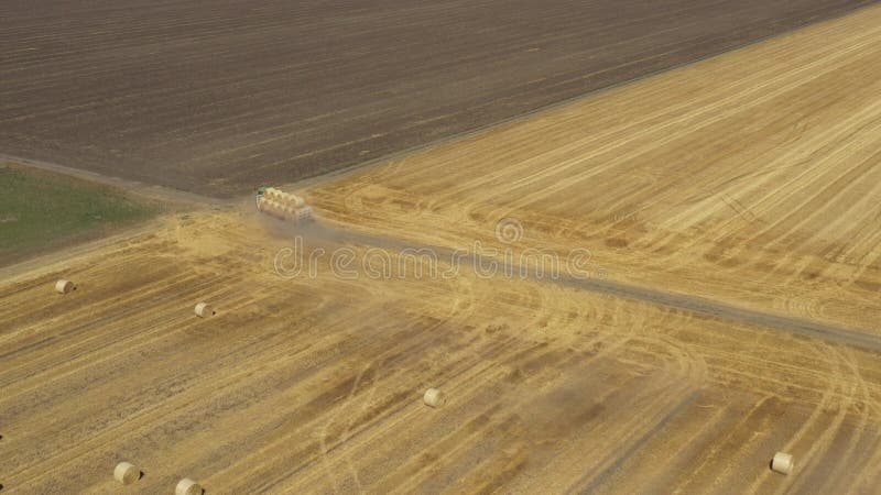 Aerial View of Tractor As Pulling Trailer Full with Round Bales of ... Aerial View of Tractor As Pulling Trailer Full with Round Bales of ...