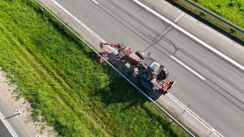 Aerial View of Tractor Mowing Grass Along Roadside Stock Footage - Video of drive, motion: 351823280
