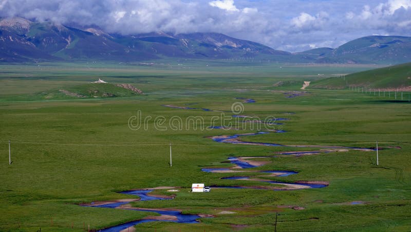 Aerial View of a Twisting Stream through a Vast Grassland in Tibet ...