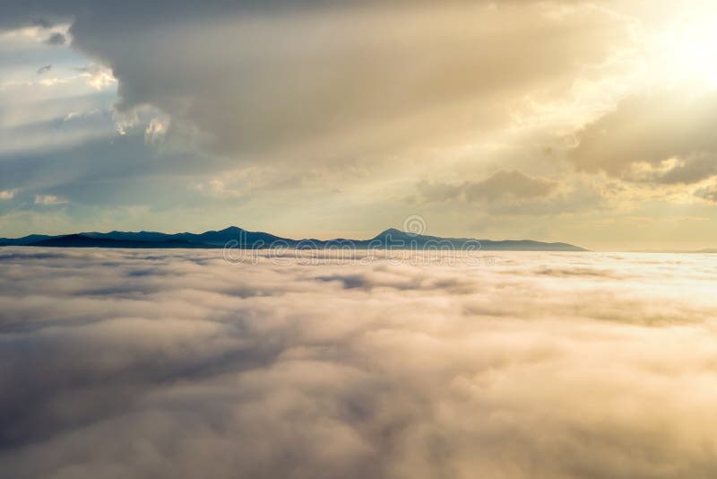 Aerial View of Vibrant Sunset Over White Dense Clouds with Distant Dark ...