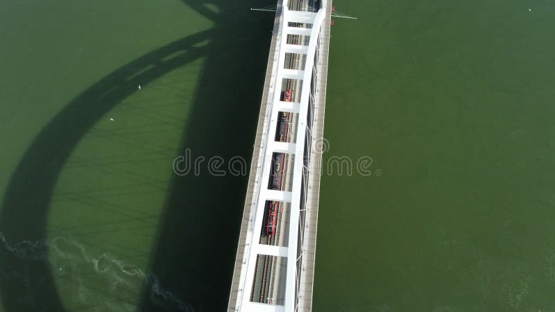 Aerial View of a White Bridge Over the River with a Moving Train Under ...