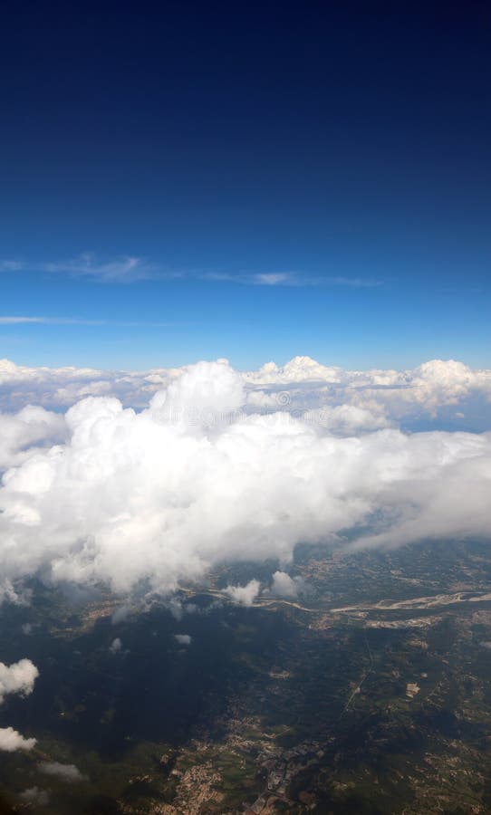 Aerial View of White Clouds from an Airplane in Flight and the Land ...