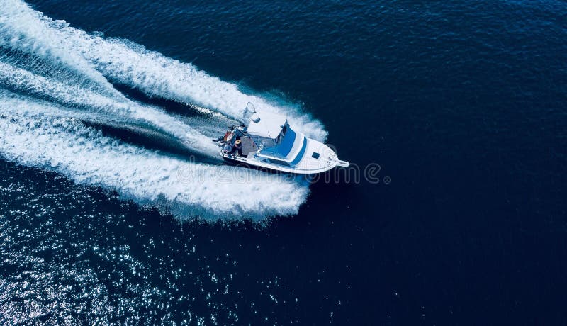 Aerial View of a White Speedboat Floating in Blue Water with White Foam ...