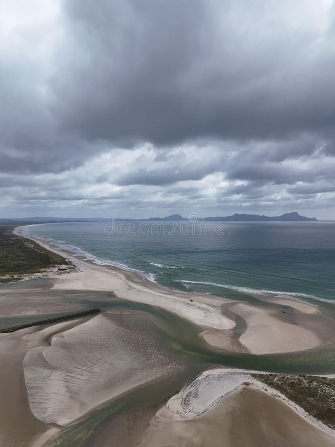 The Beach with the Blue Waters Running Down it is an Aerial View of a ...