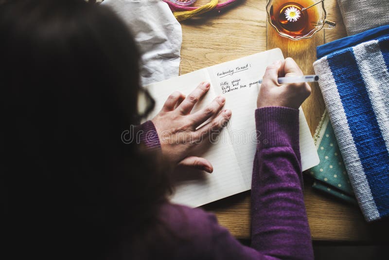 Aerial View of Woman Writing Thread Color List on Notebook Stock Image ...