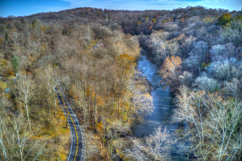 Aerial View of Woods in Fall Colors with a Road, Stream and House Stock ...