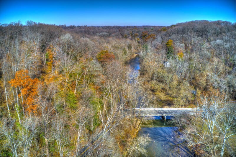 Aerial View of Woods in Fall Colors with a Road, Stream and House Stock ...