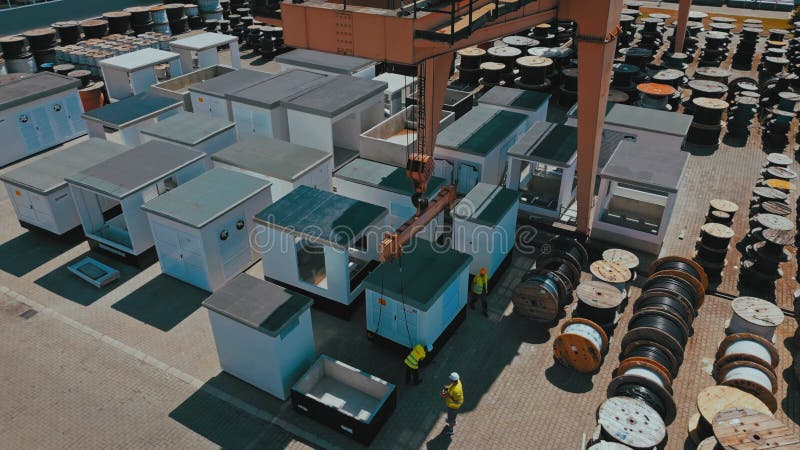 Aerial View of Workers Loading Cabins with Gantry Crane on a Sunny Day ...