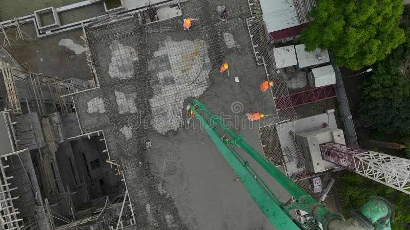 Aerial View: Workers Pour Concrete Efficiently on a Bustling Site ...