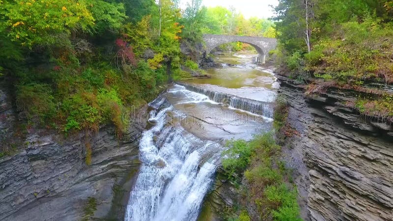 Aerial at Waterfall into Canyon Surrounded by Fall Trees with Stone ...