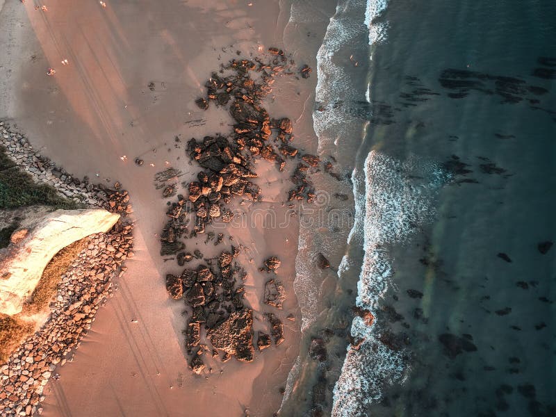 Aerial of the Waves Flowing into the Sandy Beach with Rocks. Stock ...