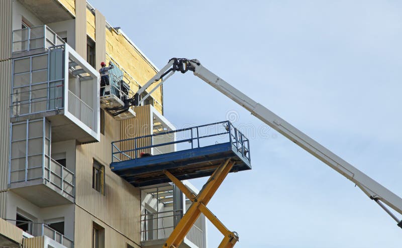 Aerial Work Platforms on an Insulation Site of a Building Stock Image ...