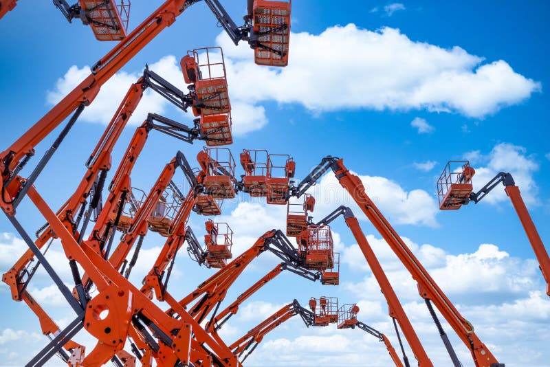 Aerial Work Platforms Lined Up of Cherry Picker Against Blue Sky with ...