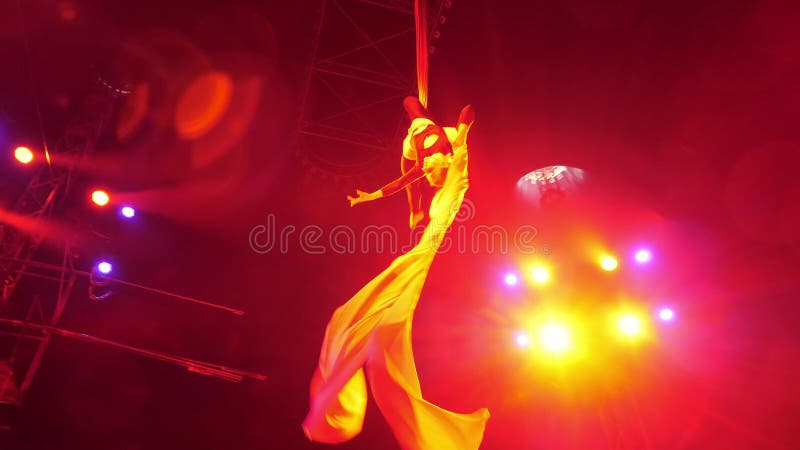 An Aerialist Performs on a Suspended Red Cloth on the Circus Stage ...