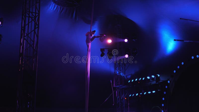 An Aerialist Performs on a Suspended Red Cloth on the Circus Stage ...