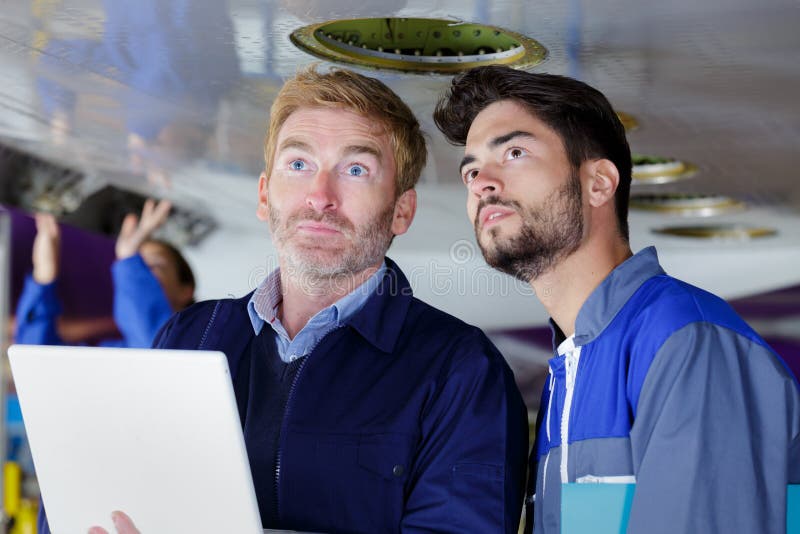 Aero Engineer and Apprentice Working in Hangar Stock Image - Image of ...