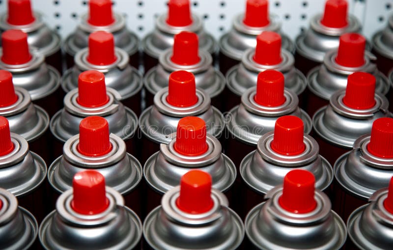 Aerosol Cans with a Bright Red Lid are in a Row. Macro Photo. Selective ...
