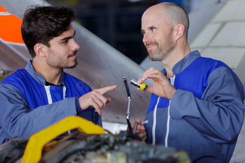 Aerospace Engineers Using Lamp To Work on Aircraft Engine Stock Photo ...