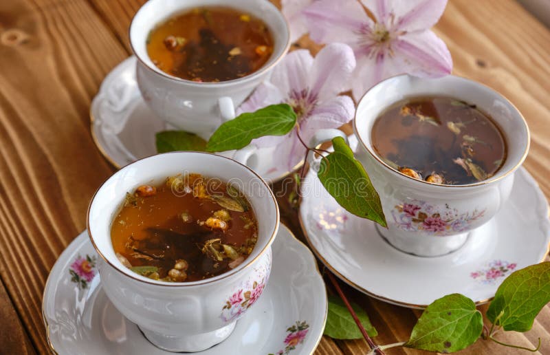 Aesthetic Shot of Cups of Tea with Flowers Inside on a Wooden Table ...
