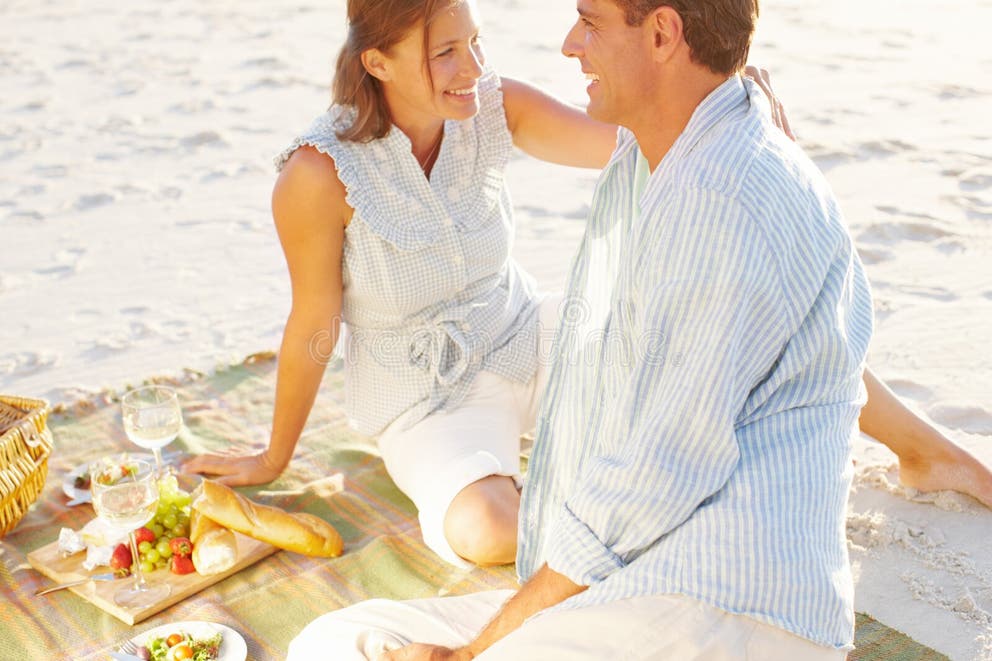 Affection at Sunset. a Devoted Couple Enjoying a Romantic Picnic on the Beach Together. Stock ...