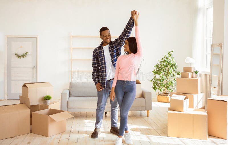 Affectionate Black Couple Dancing in Their New Apartment among ...