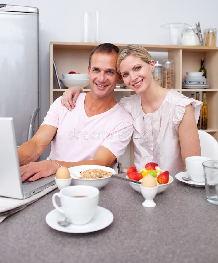Affectionate Couple Having Breakfast Stock Photo - Image of laptop ...