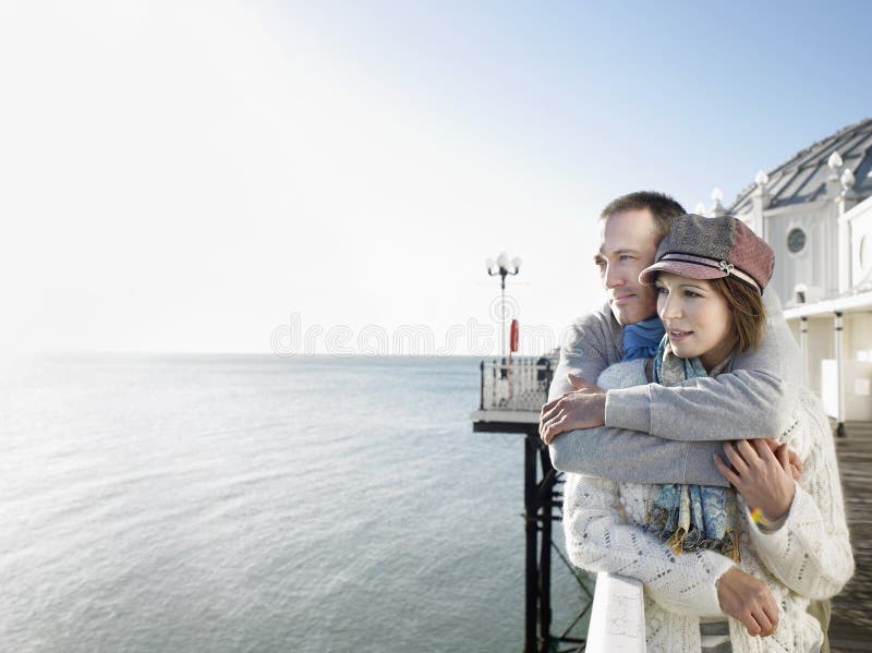 Affectionate Couple Looking Out at Sea on Pier Stock Image - Image of ...