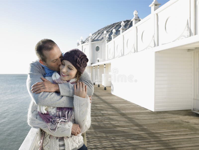 Affectionate Couple by the Sea on Pier Stock Photo - Image of ...