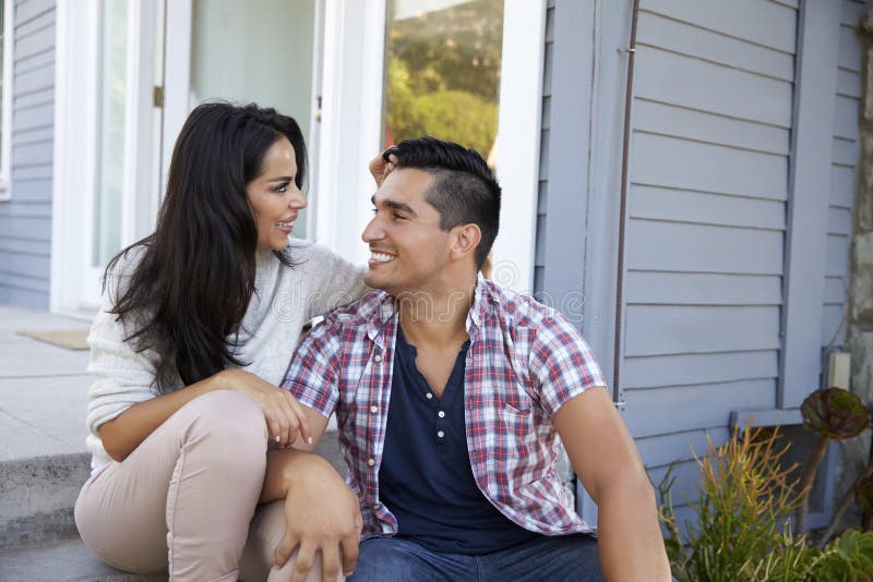 Affectionate Couple Sitting on Steps Outside Home Stock Photo - Image ...
