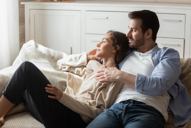 Affectionate Millennial Spouses Resting on Sofa Enjoying Comfort and ...