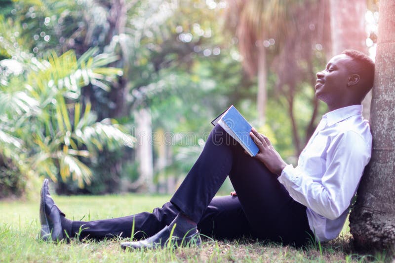 Afican Man is Sleeping Under the Tree with the Book Stock Photo - Image ...