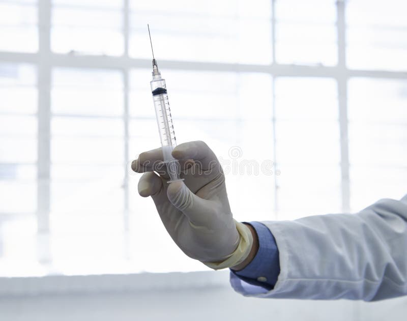 Afraid of Needles. a Doctor Standing with a Syringe. Stock Photo ...