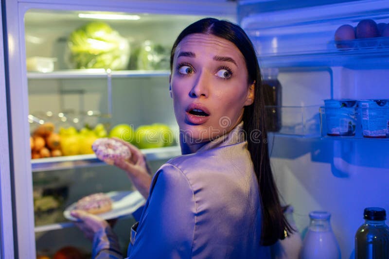 Afraid Young Woman Taking Plate with Donuts from Fridge, Having Snack ...