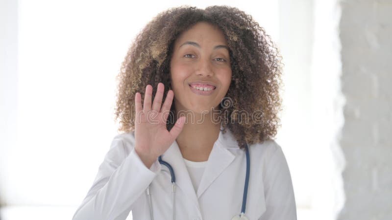 Afrcian Doctor Saying Hello by Waving Hand Stock Photo - Image of ...