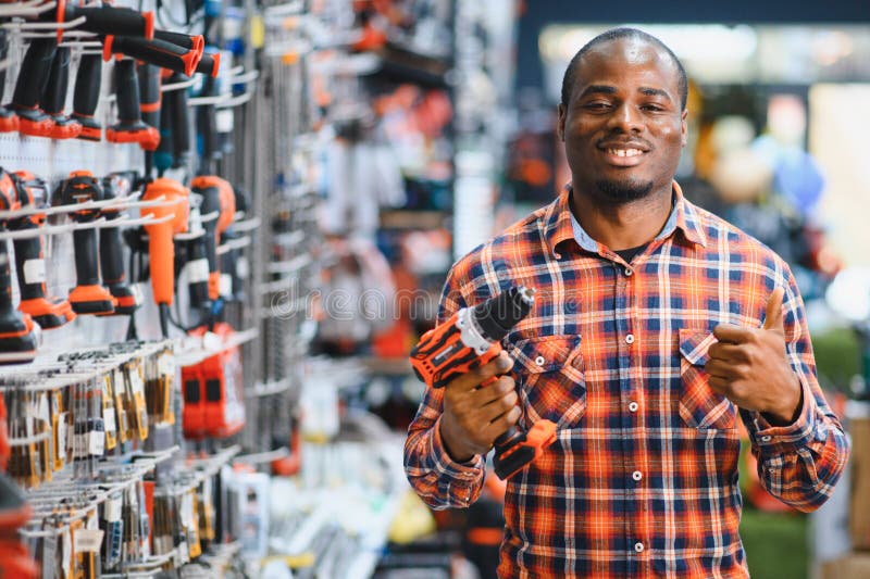 African Americam Man Buying Modern Electric Drill while Standing in ...