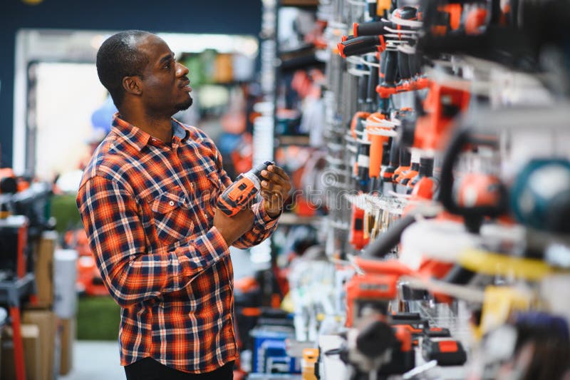 African Americam Man Buying Modern Electric Drill while Standing in ...