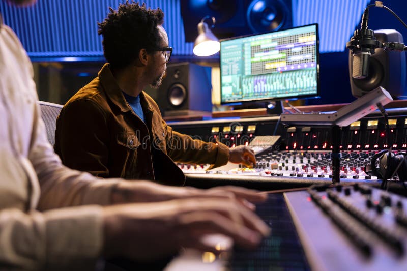 African American Audio Expert Records Artist Playing Piano in Studio ...
