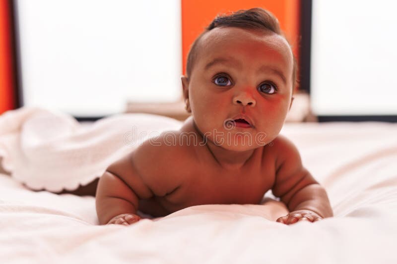 African American Baby Lying on Bed Having Legs Massage at Home Stock ...