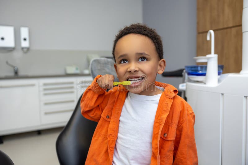 African-american Boy Looking Involved while Brushing His Teeth Stock ...