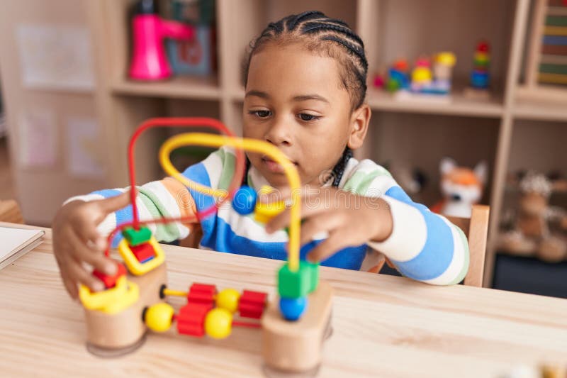 African American Boy Playing with Blocks Game Sitting on Table at ...