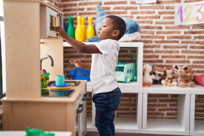 African American Boy Playing with Play Kitchen Standing at Kindergarten ...