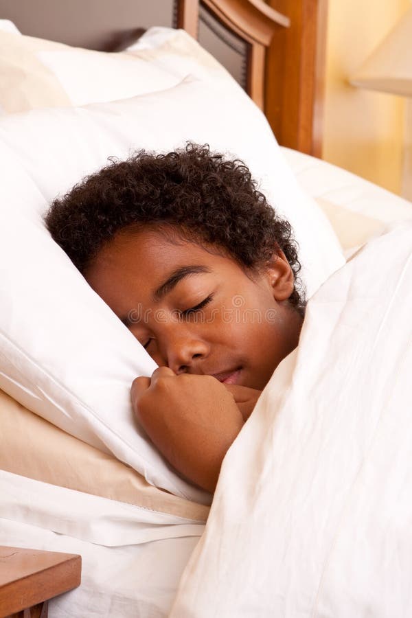 African American Boy Sleeping in His Bed. Stock Image - Image of ...