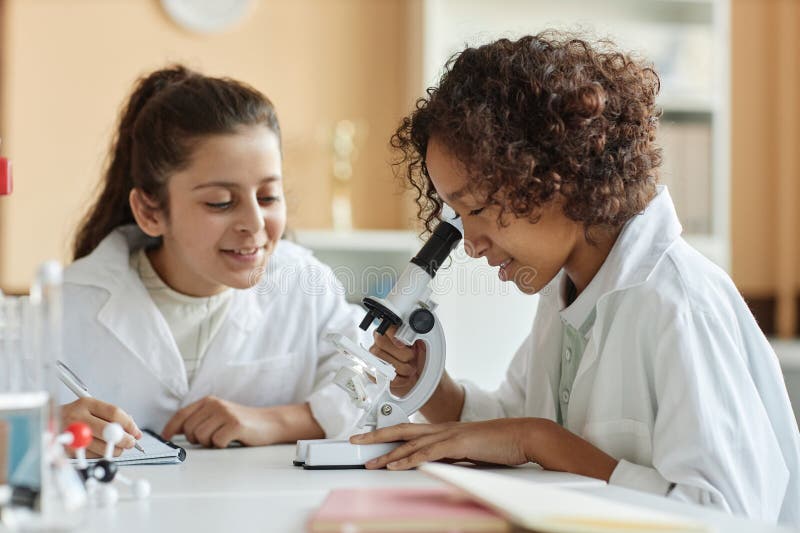 Black Boy and Middle Eastern Girl during Chemistry Class Stock Image ...