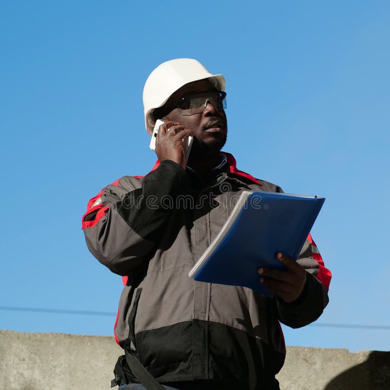 African American Builder with Work Papers Talks on Smartphone Stock ...